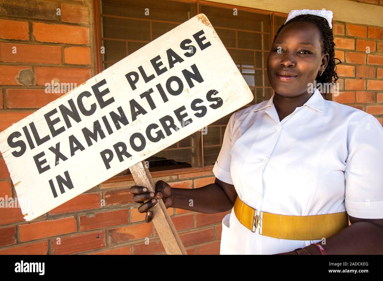 Nursing exam. Nurse holding a sign asking for silence during an ...