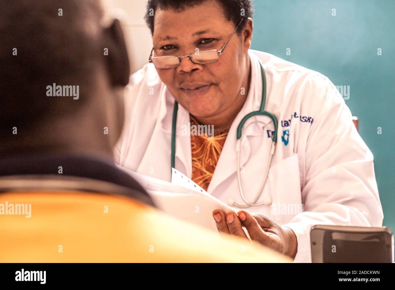 Hospital consultation. Hospital doctor talking to a patient to assess ...