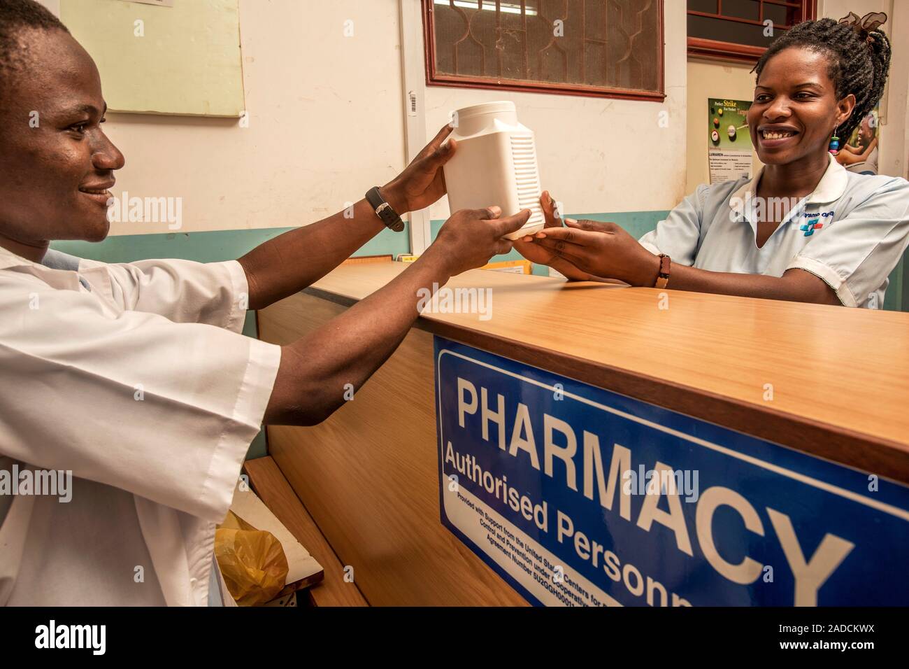Hospital pharmacy. Pharmacist dispensing drugs to a nurse in a hospital ...