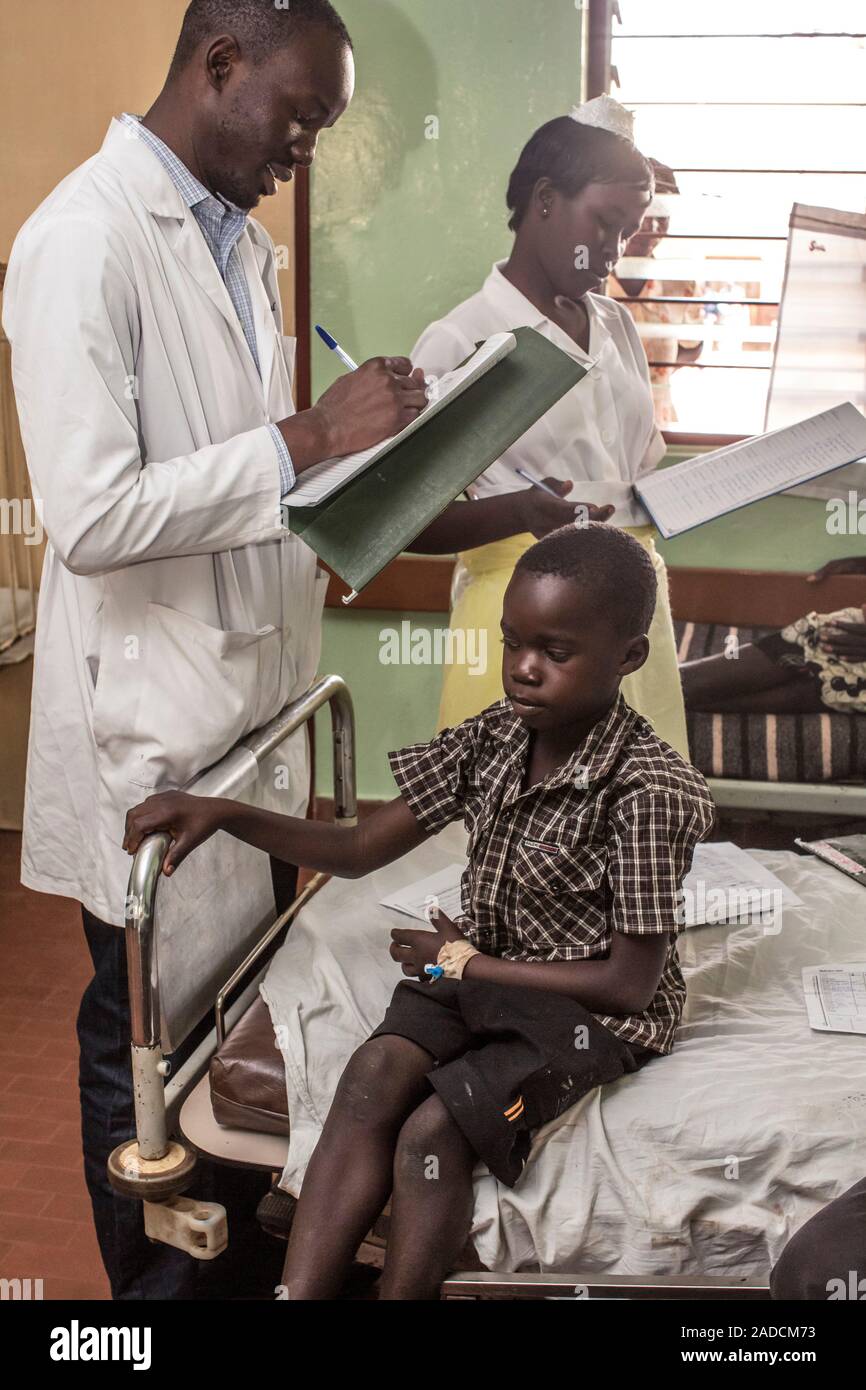 Hospital ward notes. Doctor and nurse writing notes on a child patient ...