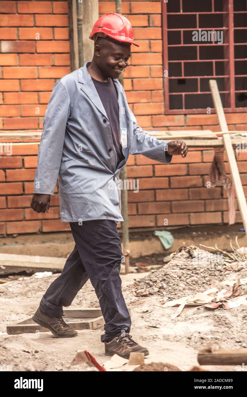 Construction worker with a hard hat on a building site. Photographed in ...