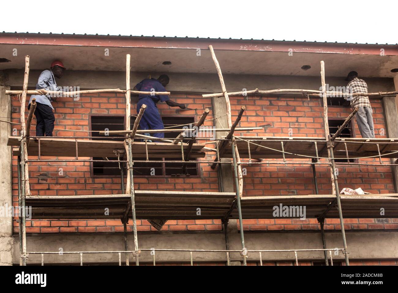 Construction workers on scaffolding on a building site. Photographed in ...