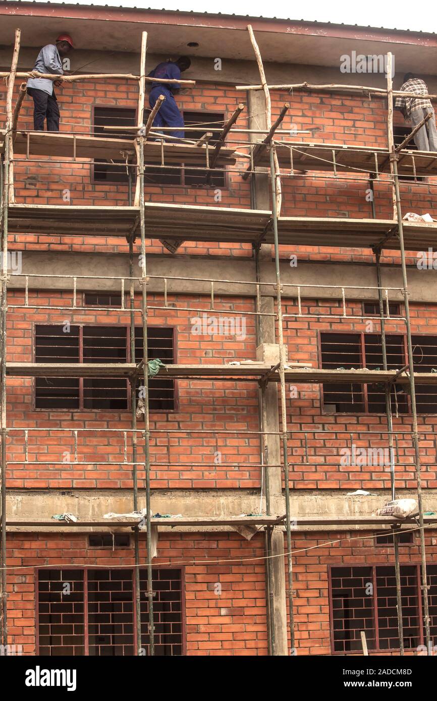 Construction workers on scaffolding on a building site. Photographed in ...