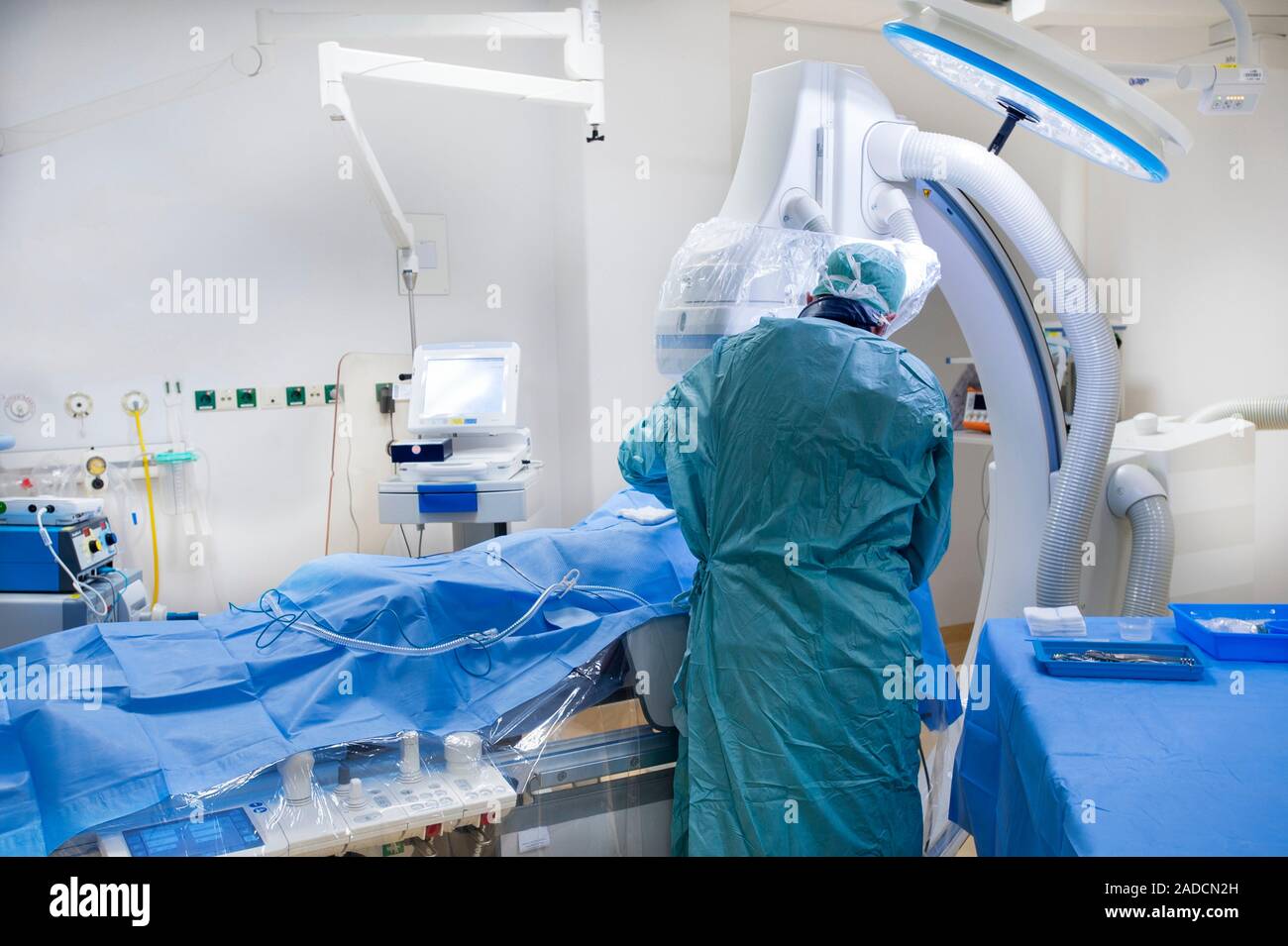 Implantable defibrillator surgery. Surgeon carrying out surgery to fit ...