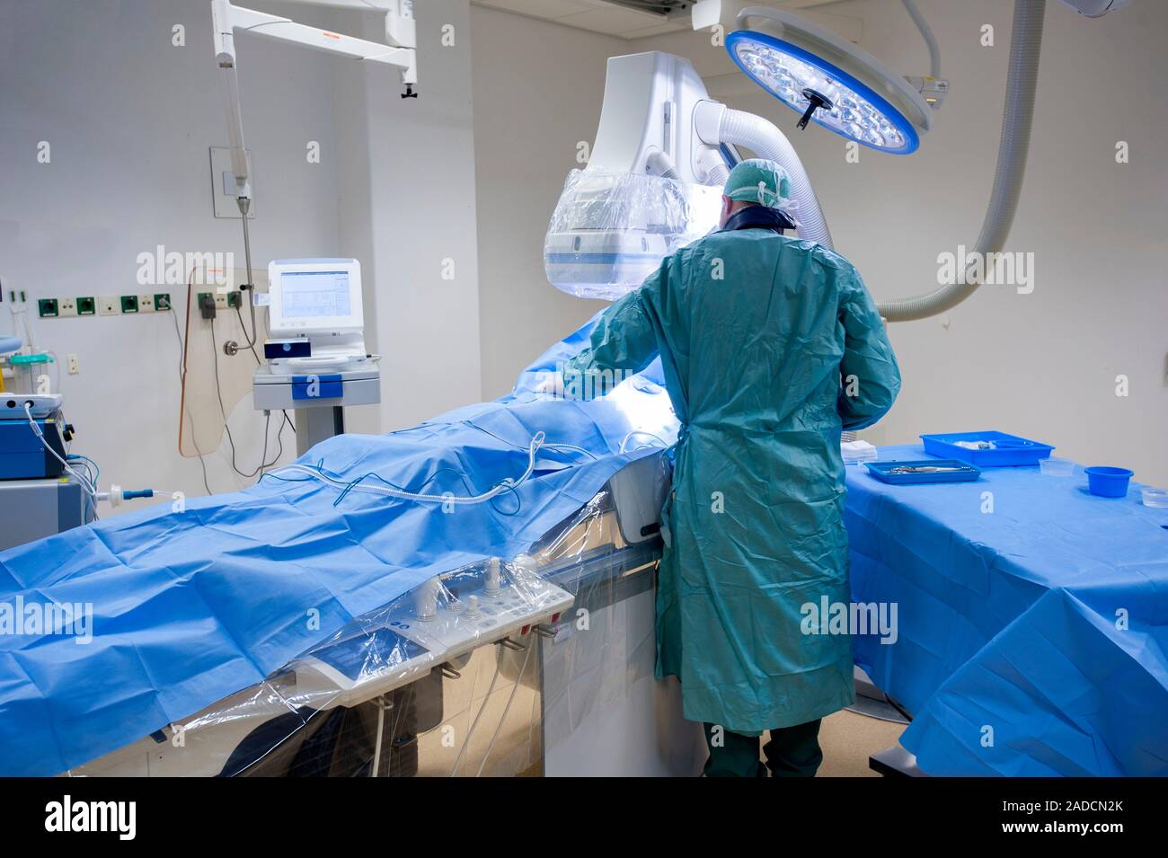 Implantable defibrillator surgery. Surgeon carrying out surgery to fit ...