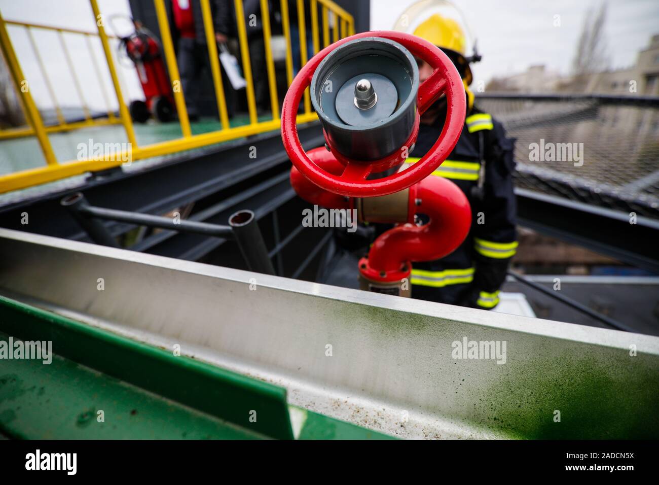 Details with the hands of a firefighter holding a fire suppression ...