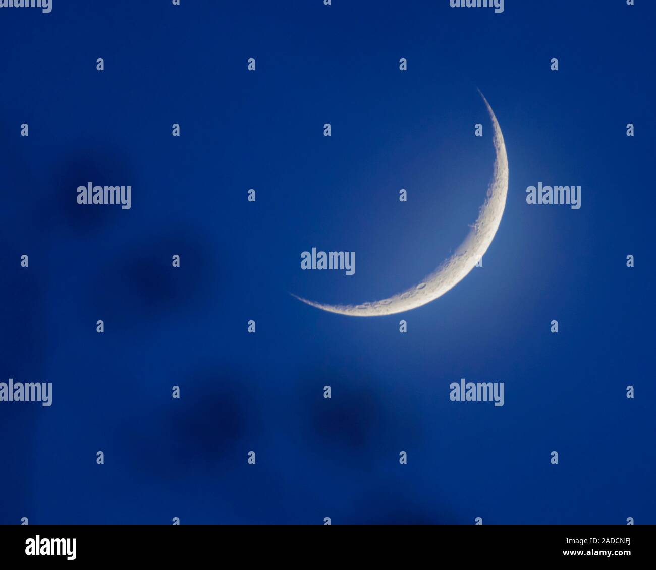 Crescent moon. View of the crescent moon at dusk, showing the craters ...