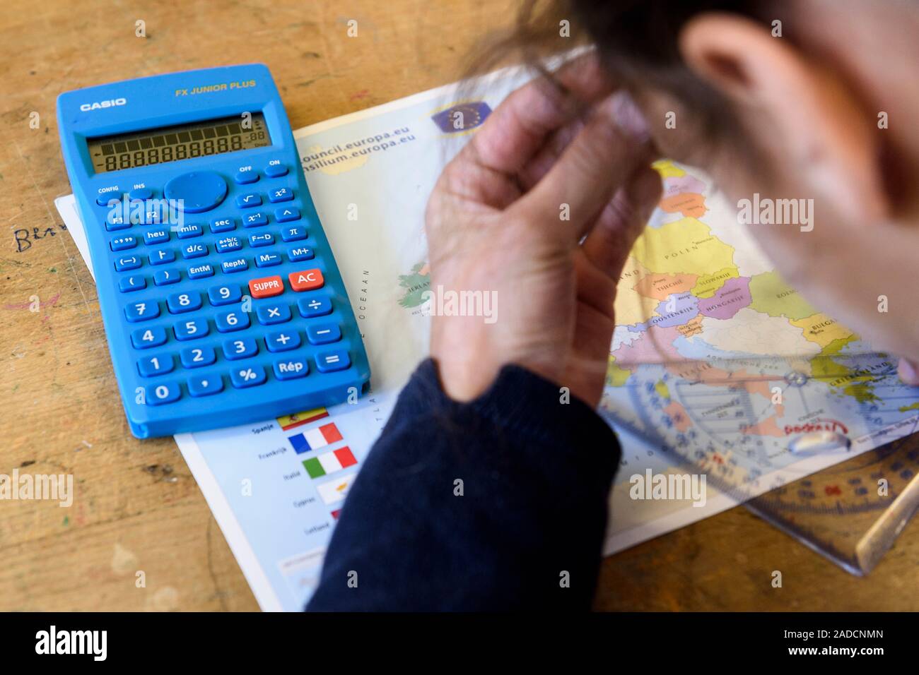 School work. A student with a calculator, map and protractor Stock ...