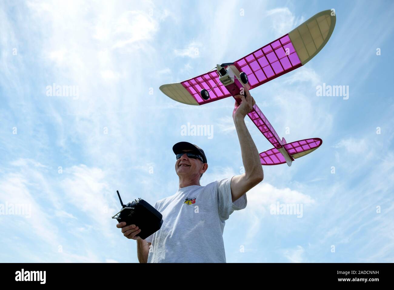 A model aircraft enthusiast launching his remote-controlled plane Stock ...