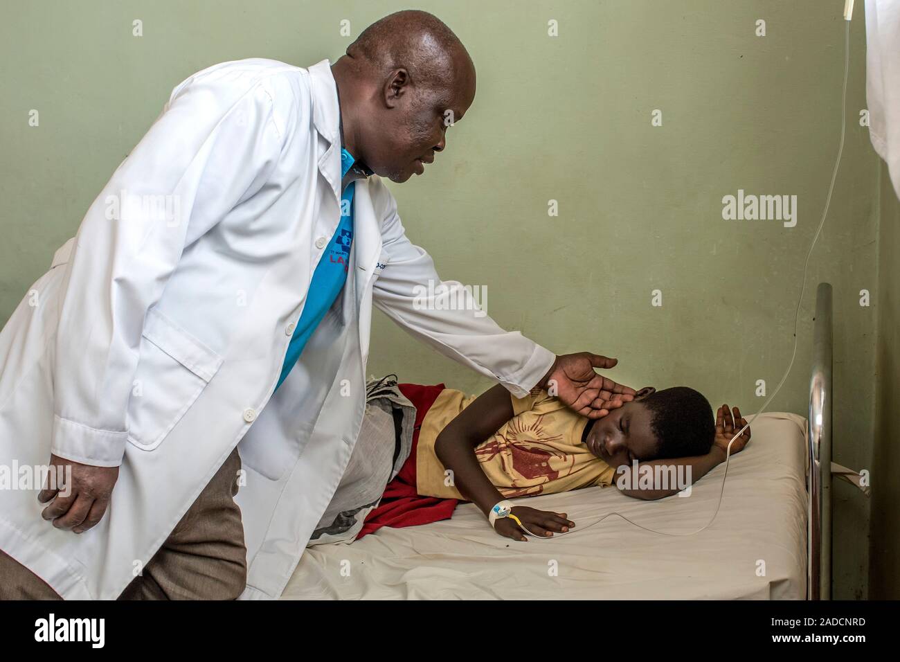 Hospital doctor and child. Hospital doctor caring for a child patient ...