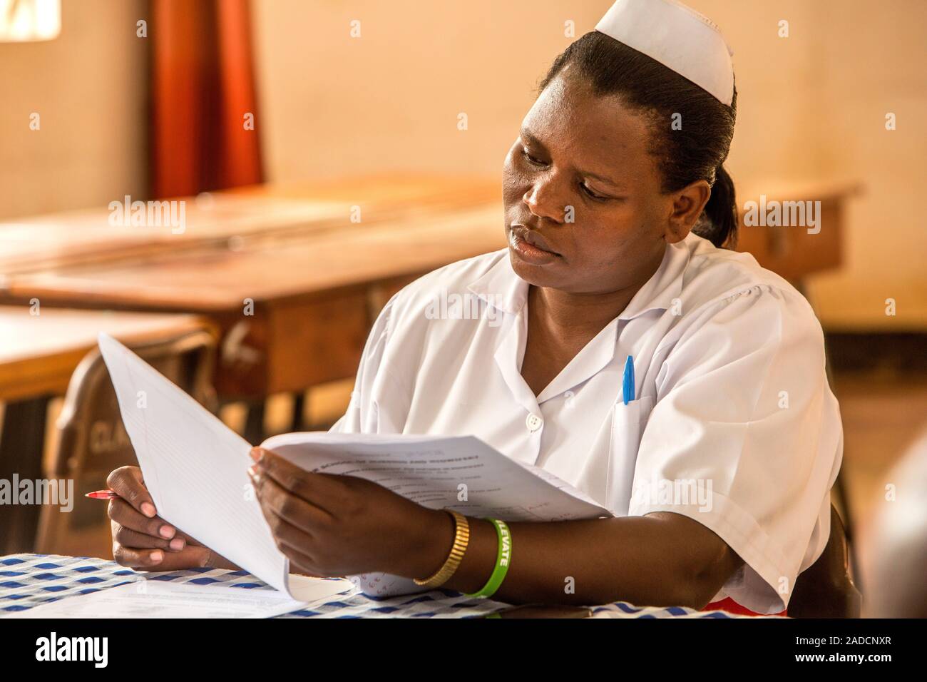 Hospital nurse reading notes at a meeting. Photographed in St Mary's ...