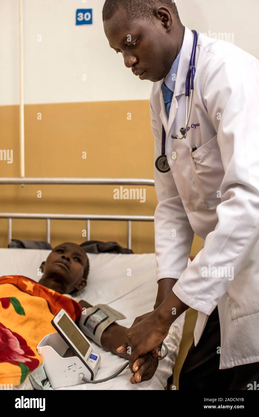 Hospital blood pressure measurement. Hospital doctor measuring a ...