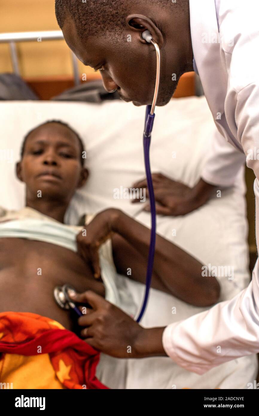 Hospital examination. Hospital doctor examining a patient with a ...