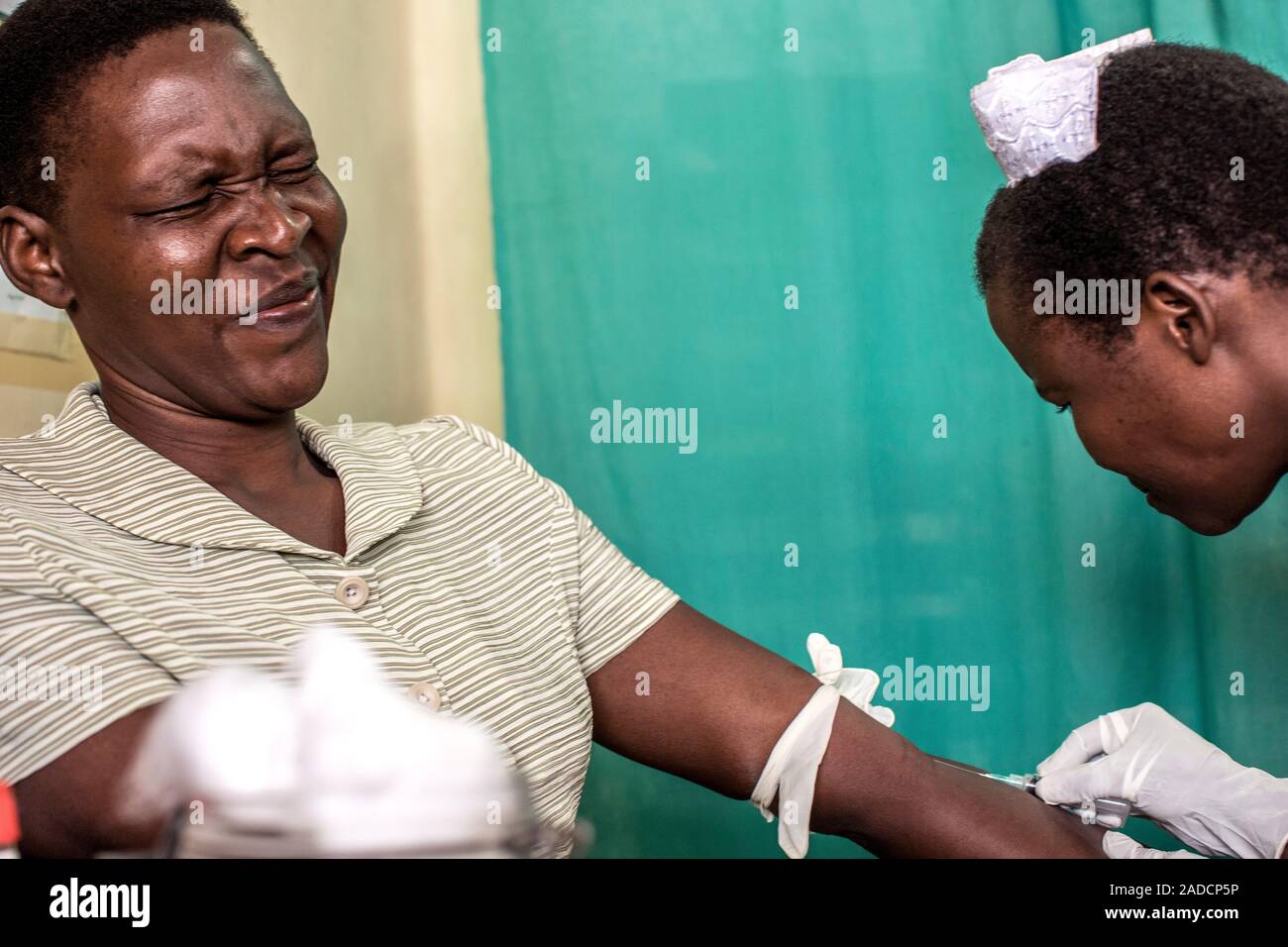 Taking blood sample. Nurse extracting a blood sample from a patient's ...