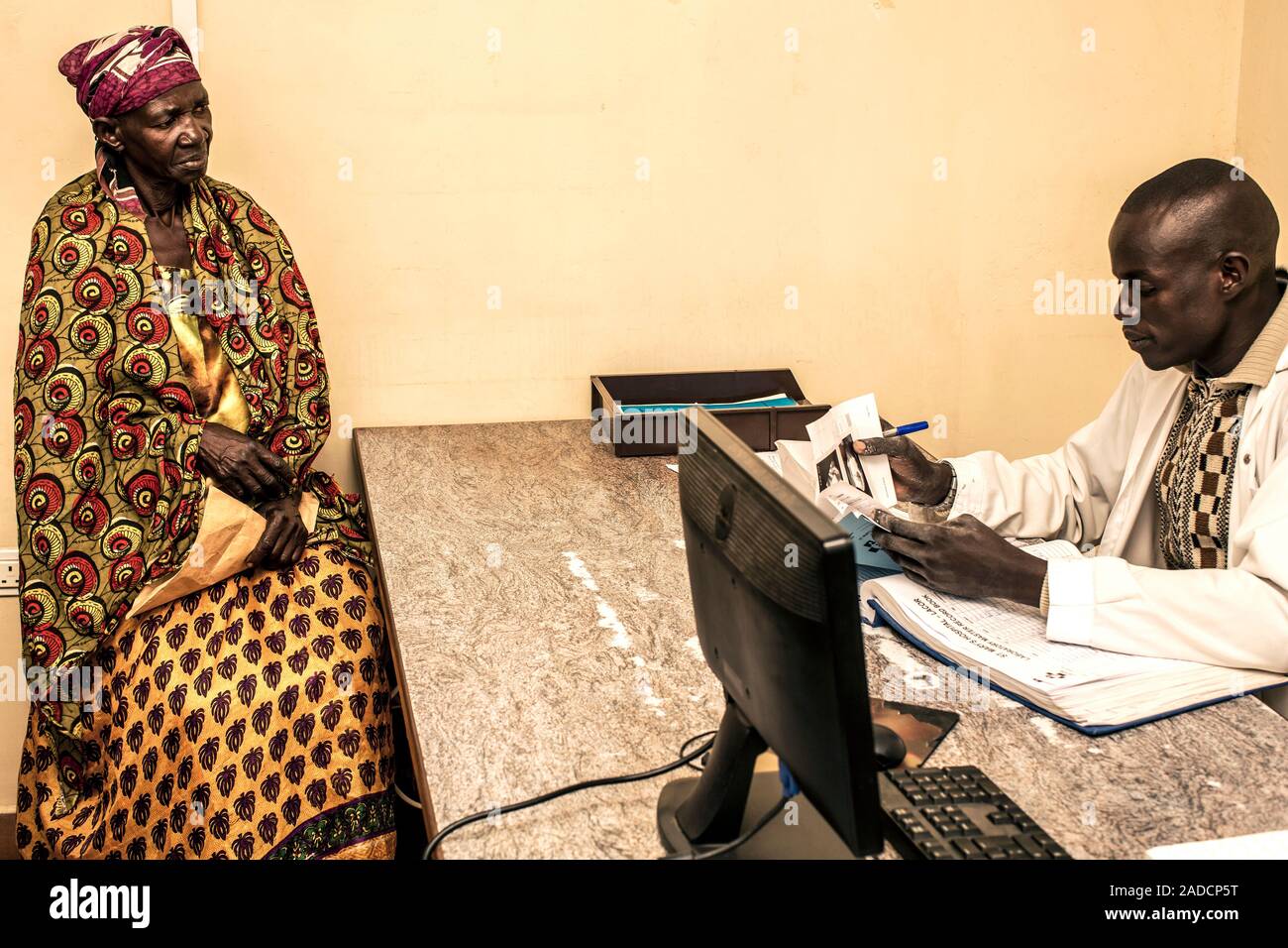 Hospital consultation. Hospital doctor talking to a patient to assess ...