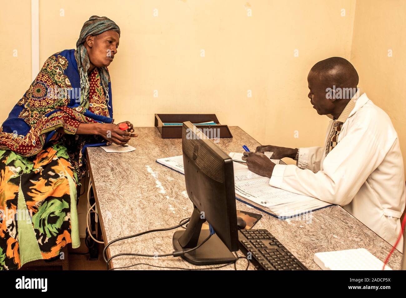Hospital consultation. Hospital doctor talking to a patient to assess ...