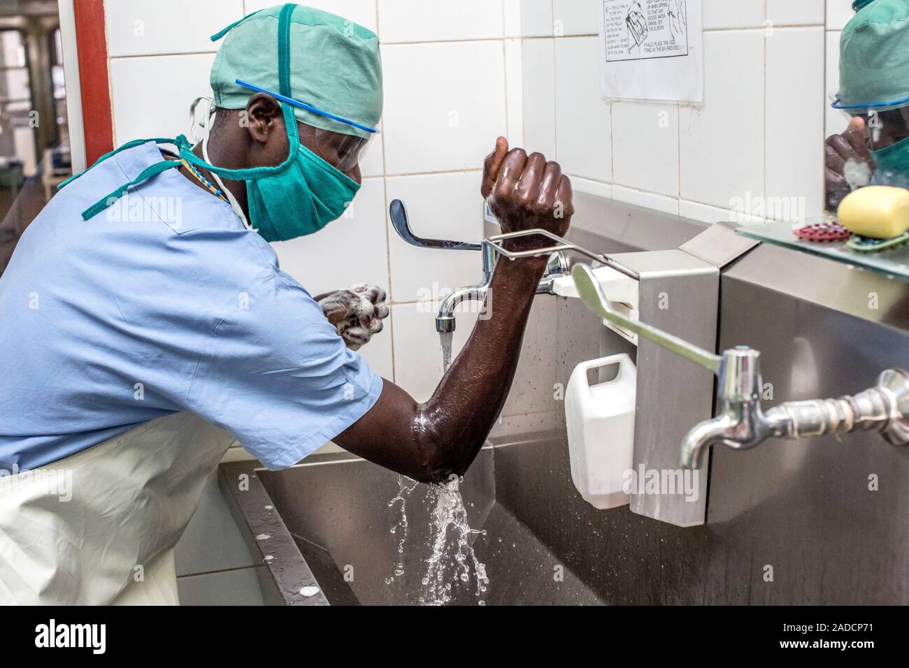 Surgeon washing his hands. Hospital surgeon cleaning his hands with ...