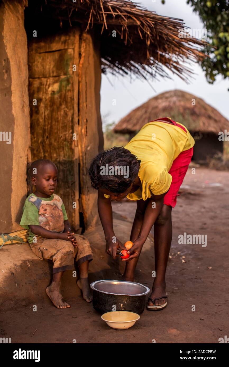 Mother and son preparing food in a village. Photographed in a rural ...