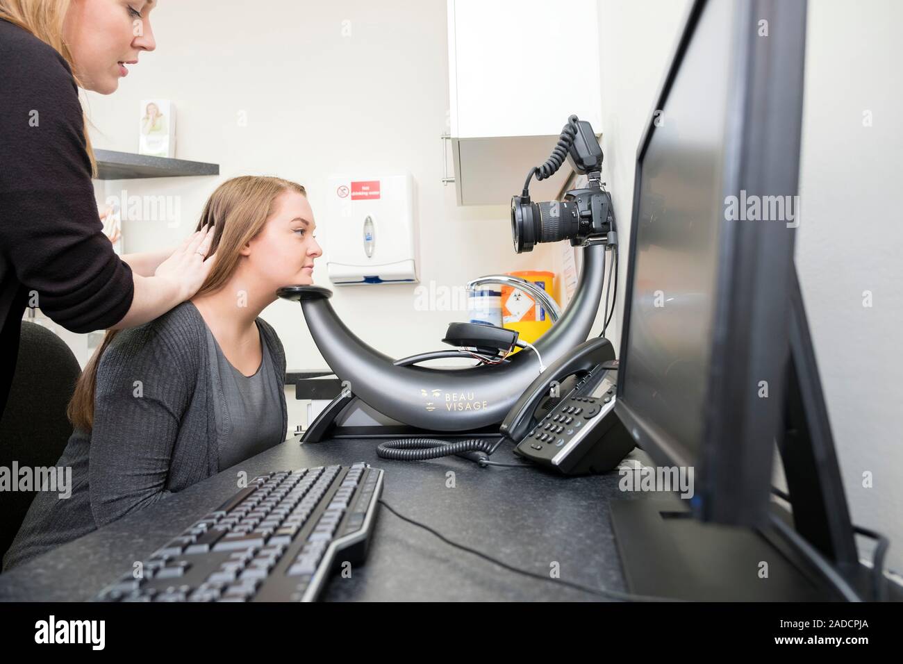 Skin health analysis scanning. Cosmetic skincare patient having the ...