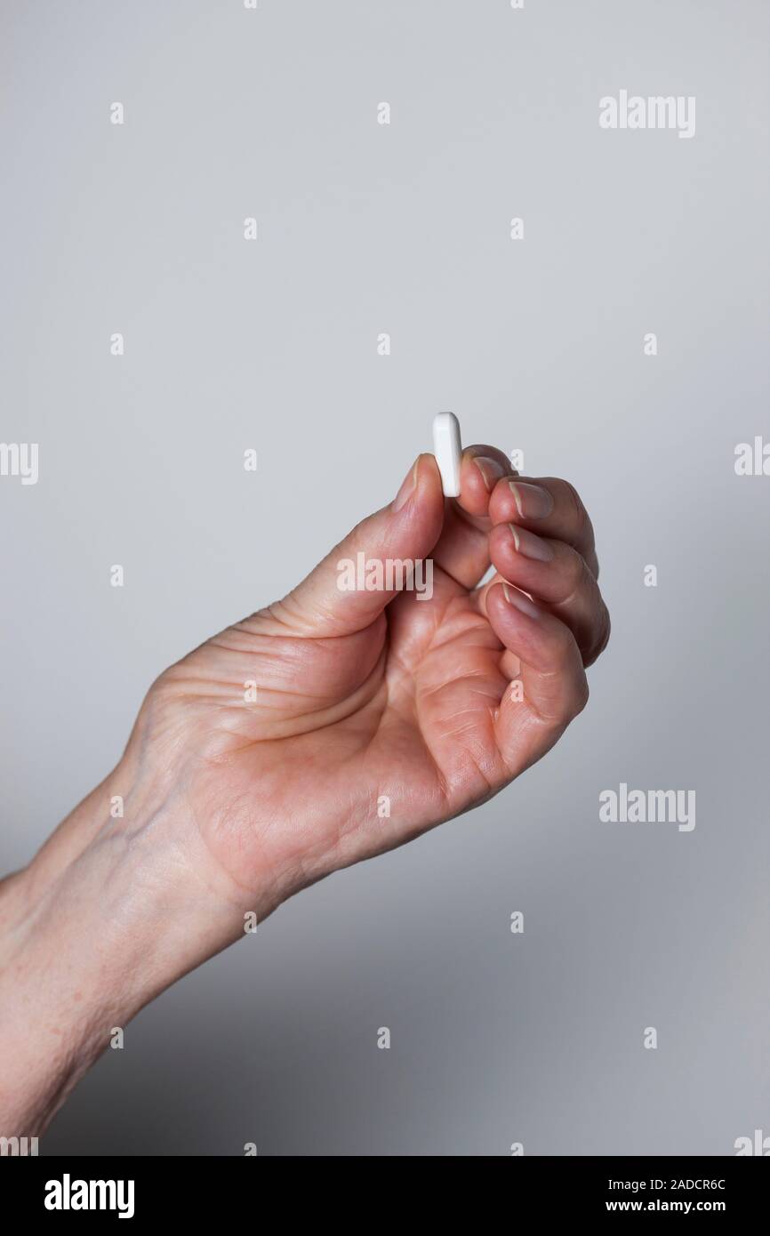 Elderly patient taking a pill Stock Photo - Alamy