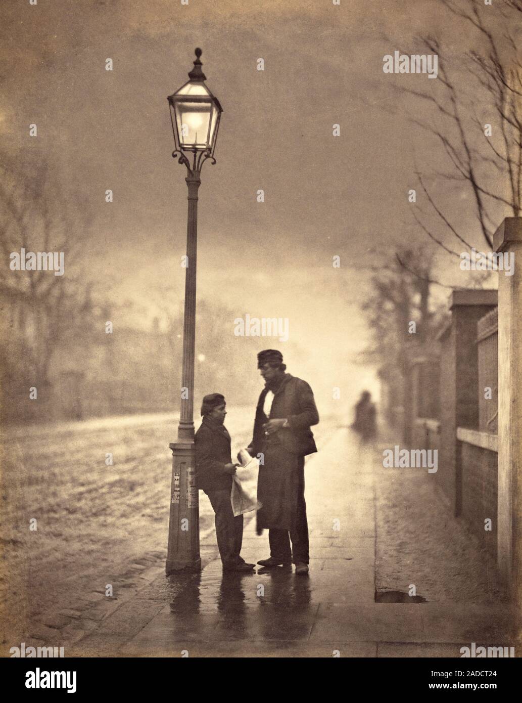 Twilight street scene, circa 1860, showing a man and boy with a ...