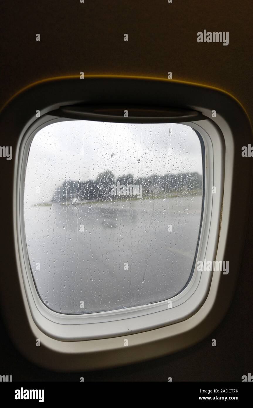 Passenger economy class cabin window of Embraer ERJ-135LR taxiing with ...
