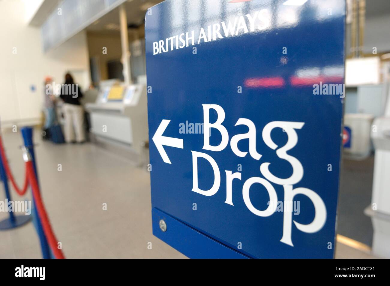 Passengers checking-in at British Airways self-service check-in kiosks ...