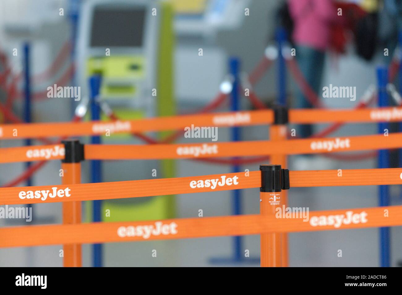 EasyJet logos on check-in passenger barriers in Manchester Airport ...