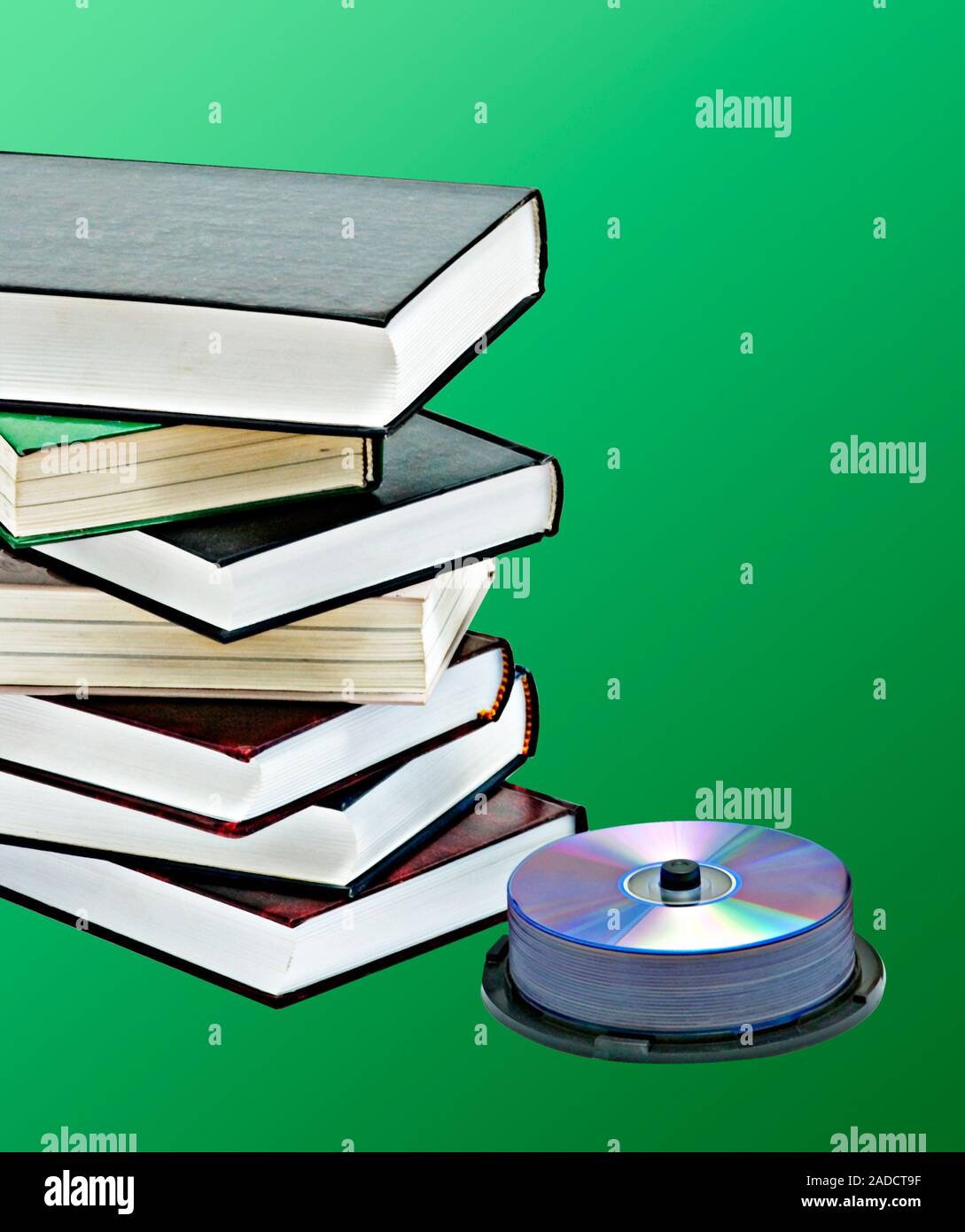 Pile of books and DVD pack as symbols of old and new methods of ...