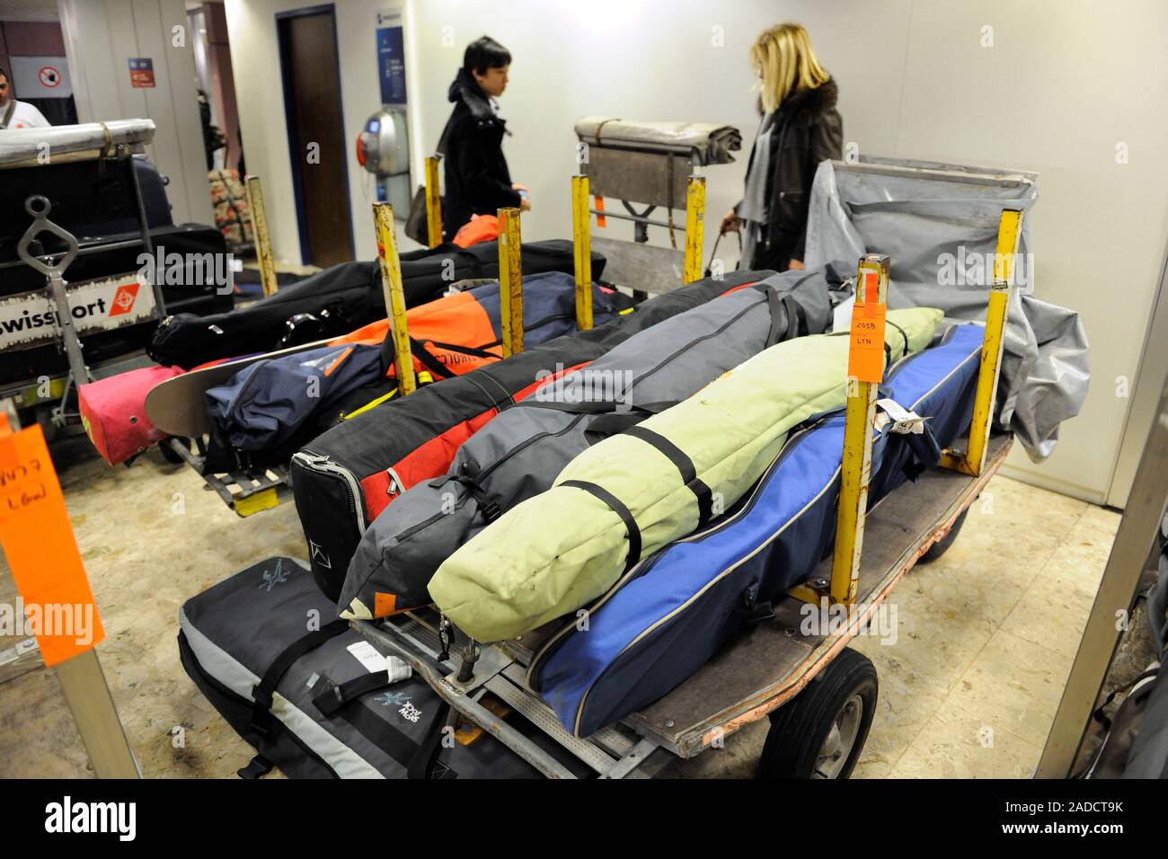 Busy airport baggage reclaim area. Passengers waiting for baggage and ...