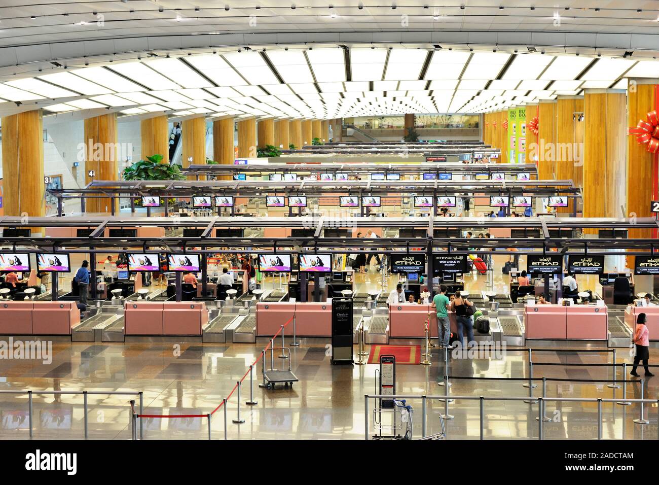Passengers with bags at the check-in desks in Terminal 2 of Singapore ...