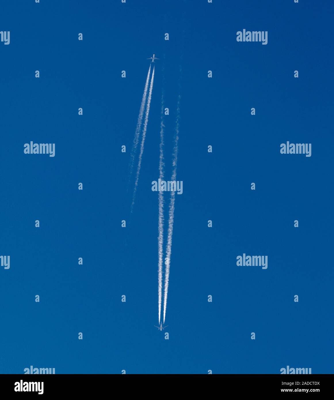 Boeing 767 and Airbus A330 with contrails flying overhead Stock Photo ...