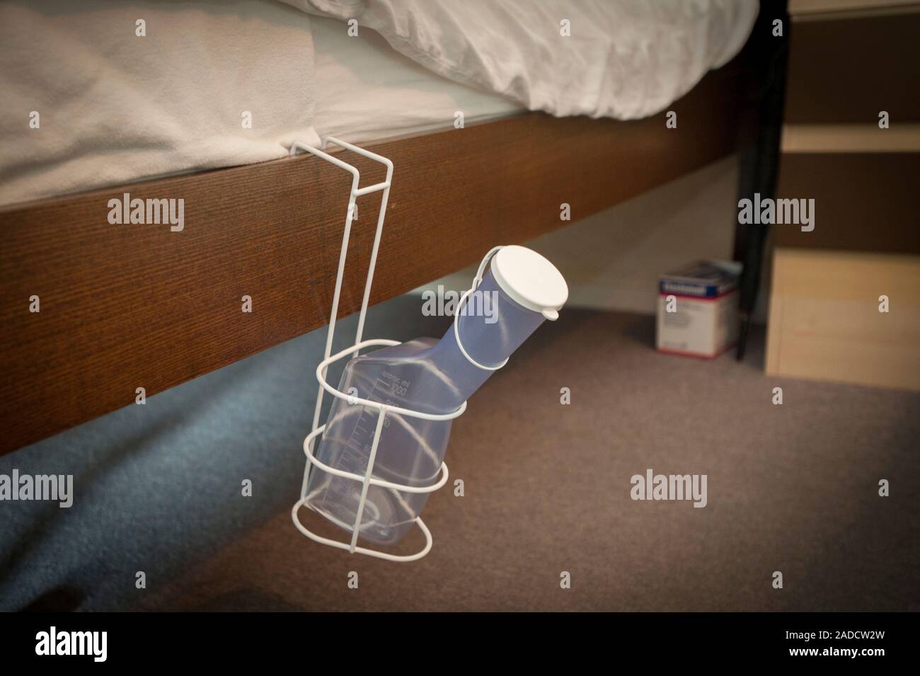Urine bottle. Close-up of a urine bottle attached to the side of a ...