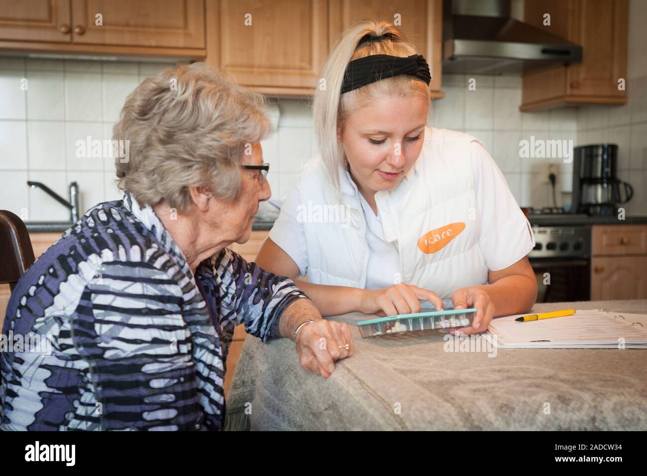 Home care nursing. Nurse explaining a older patient's medication to her ...
