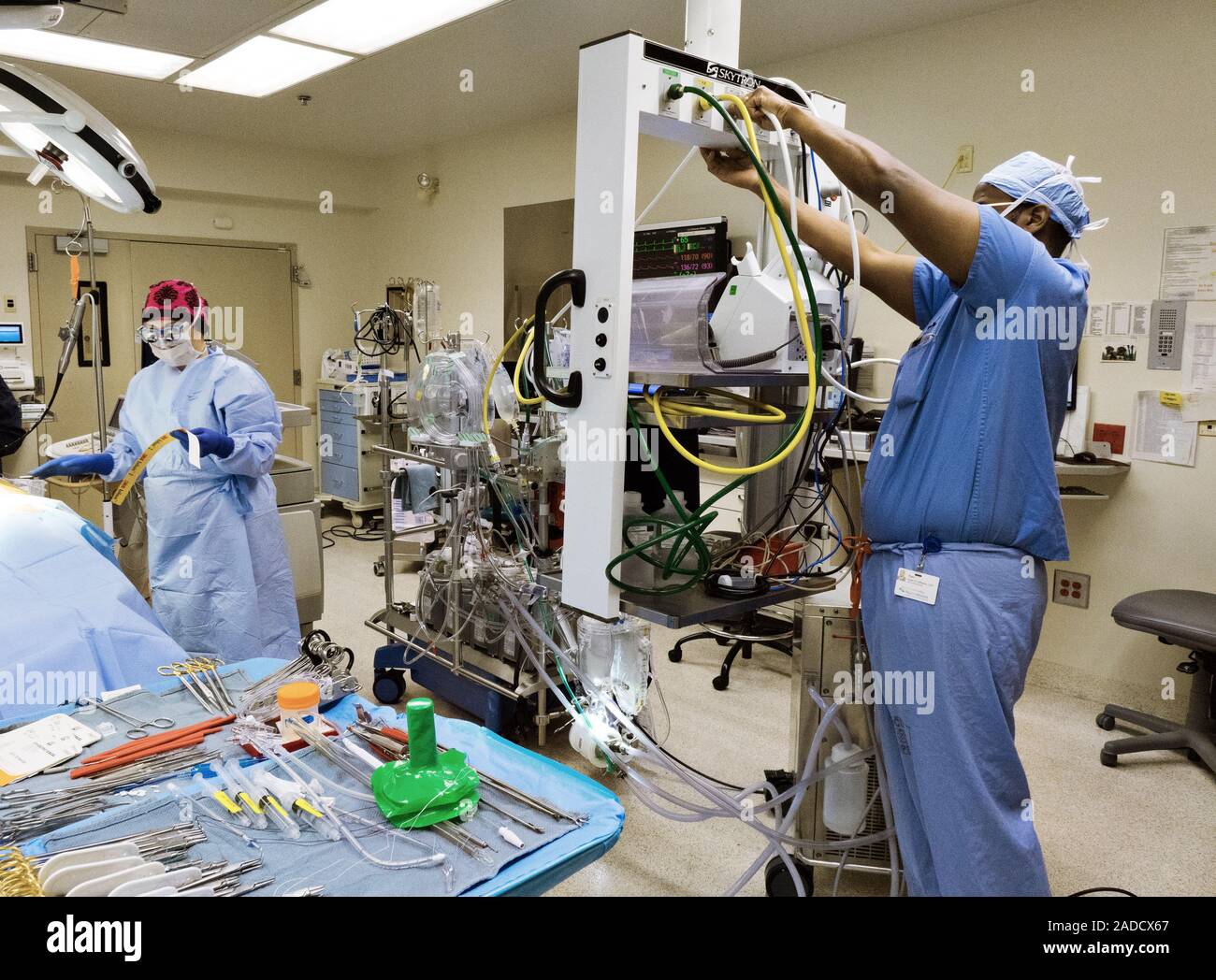 Open heart surgery preparations. Surgical team preparing for open heart surgery, with the heart ...