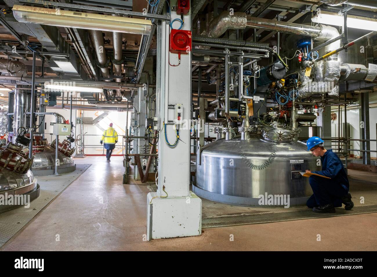 CalaChem chemical factory. Worker checking a cryogenic stainless steel ...
