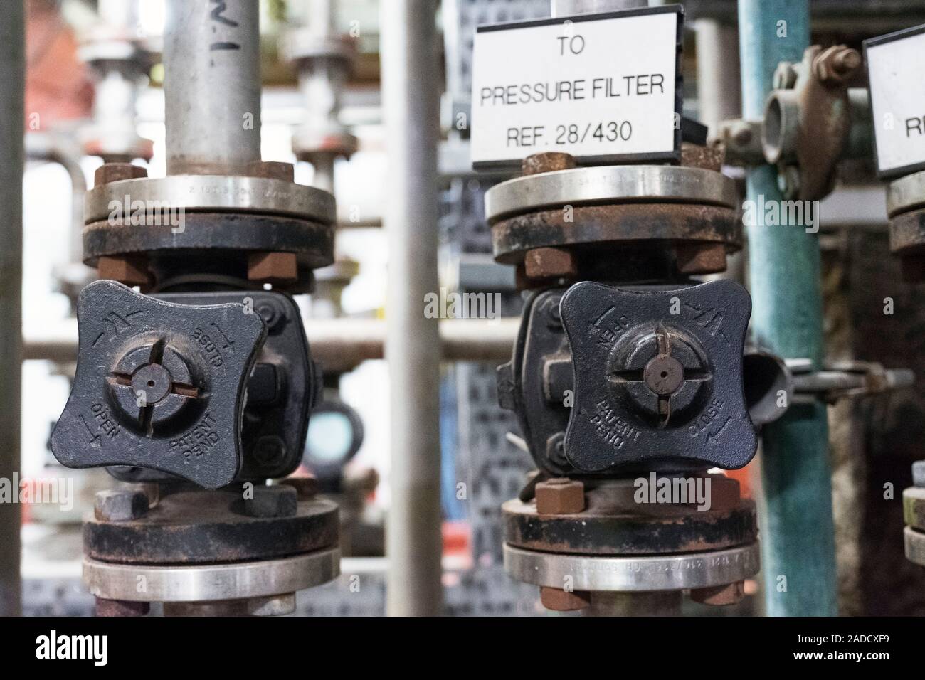 CalaChem chemical factory. Pressure valves on pipes at the CalaChem ...