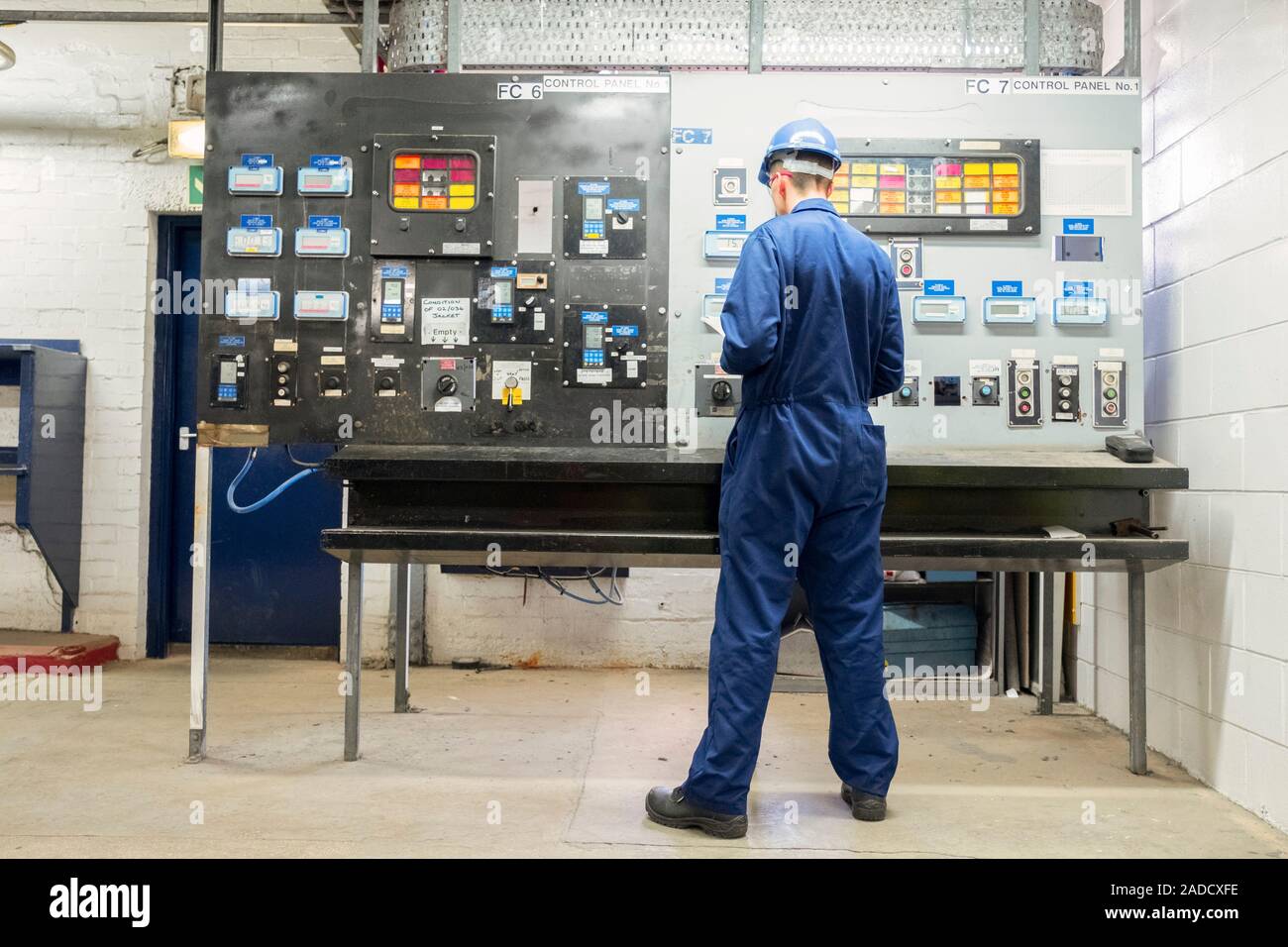 CalaChem chemical factory. Worker taking pressure and level readings in ...