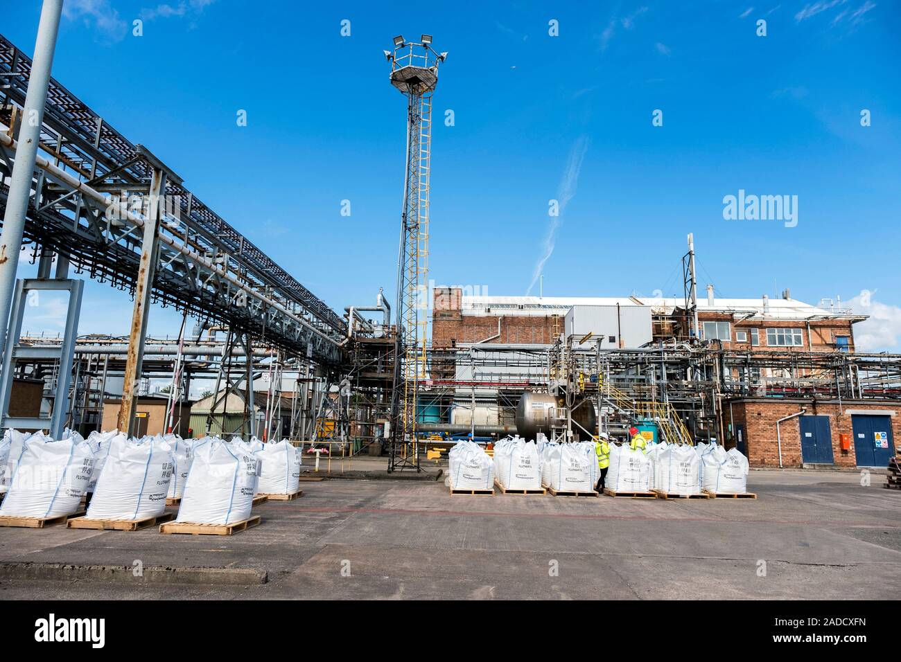 CalaChem chemical factory. Workers checking sacks of flutriafol ...