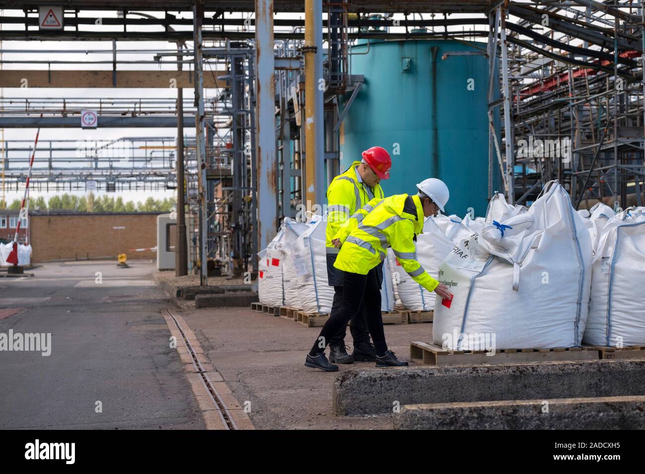 CalaChem chemical factory. Workers checking sacks of flutriafol ...