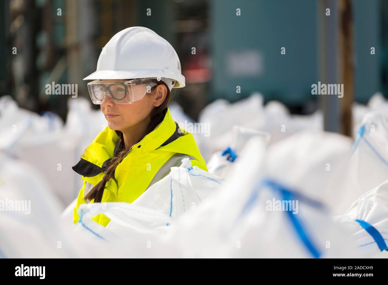 CalaChem chemical factory. Worker with sacks of flutriafol fungicide ...