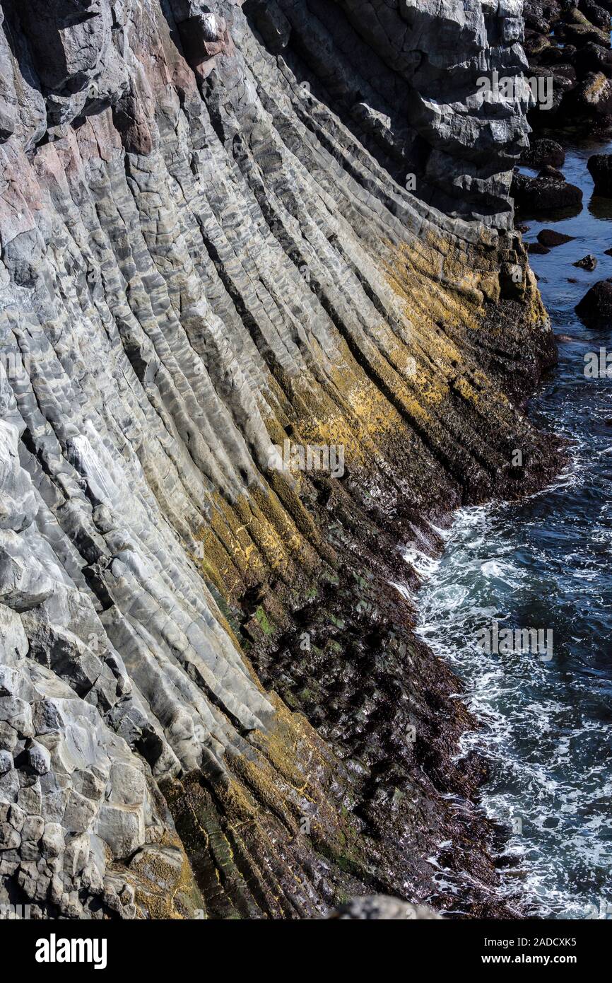 When deep flows of liquid basalt flow from eruptions it may cool into ...