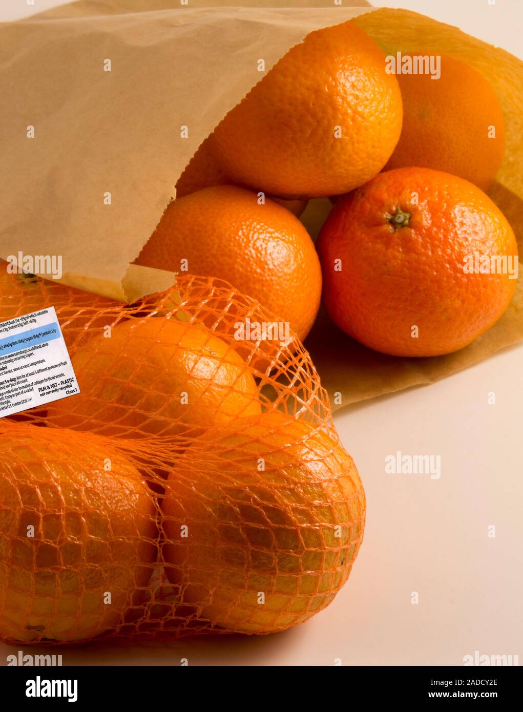 Oranges packed in a mesh bag (net polybag) made from a synthetic mesh ...