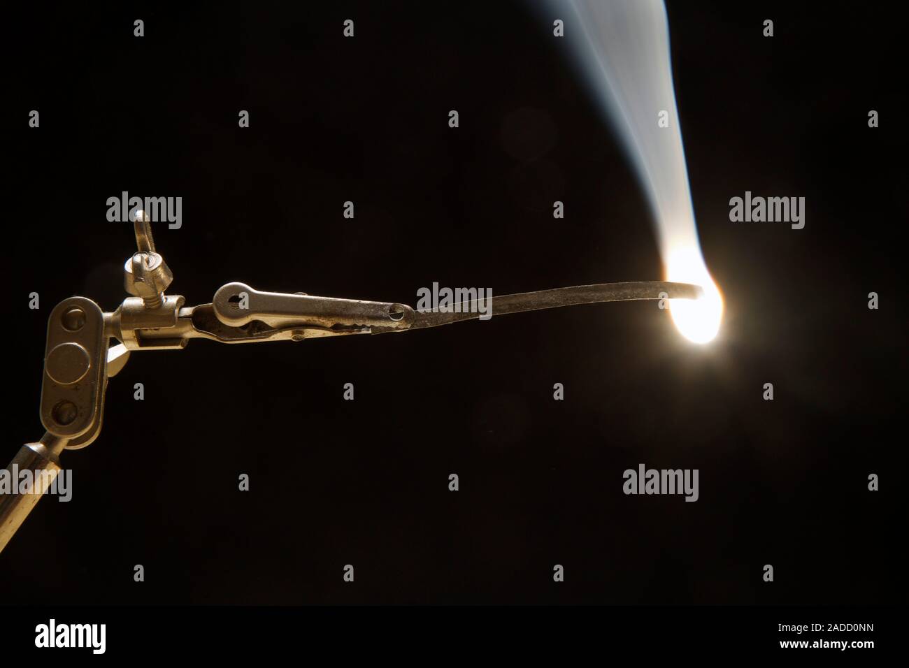 Magnesium burning. Magnesium burns producing brilliant white light. As ...