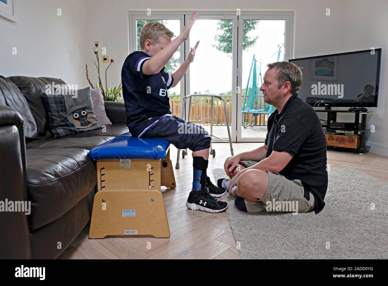 Cerebral palsy patient doing exercises. 10-year-old boy with cerebral ...