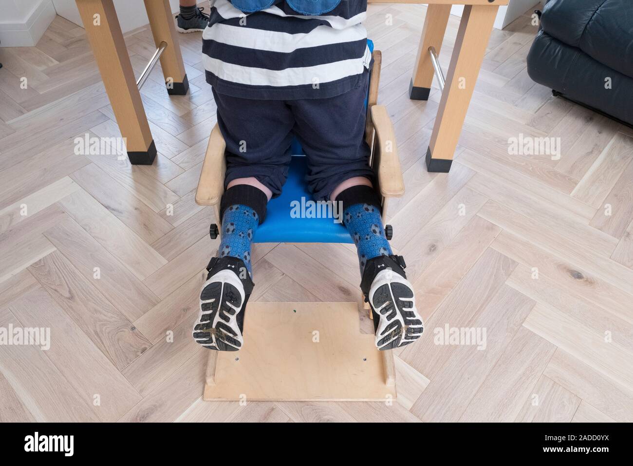 Boy with cerebral palsy. 10-year-old boy with cerebral palsy kneeling ...