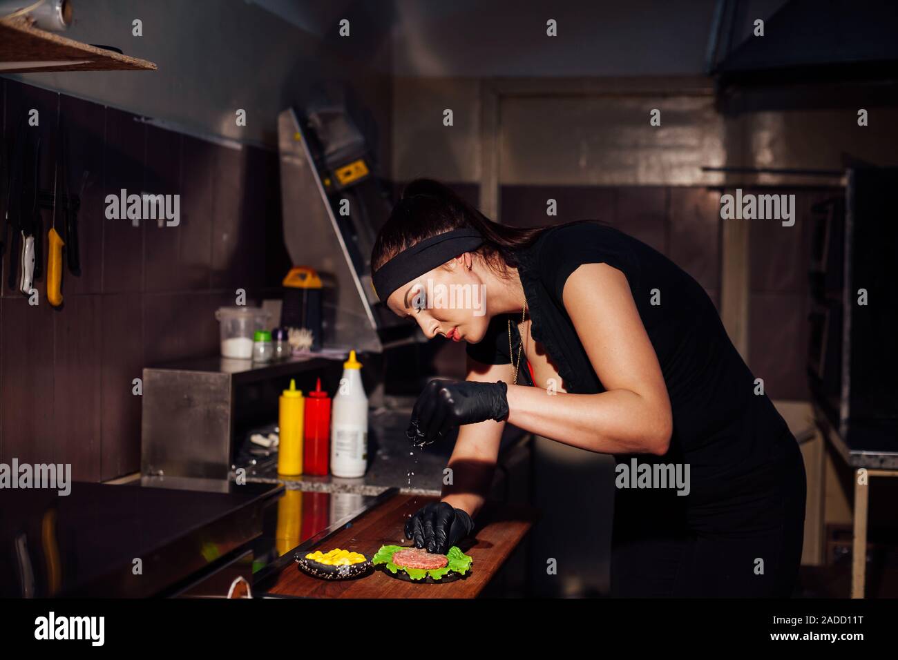 beautiful girl Cook prepares the kitchen Burger Stock Photo - Alamy