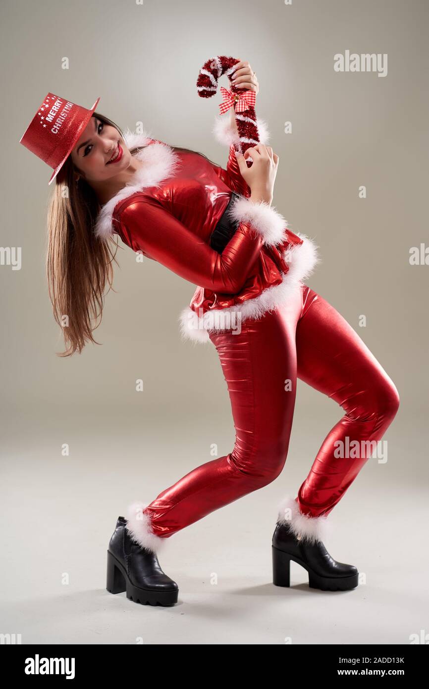 Beautiful Santa woman in red costume over gray background Stock Photo ...