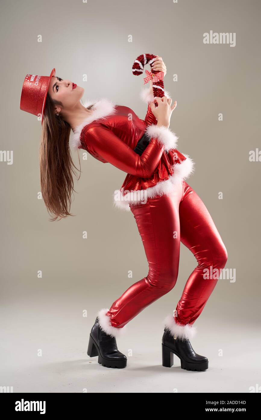 Beautiful Santa woman in red costume over gray background Stock Photo ...