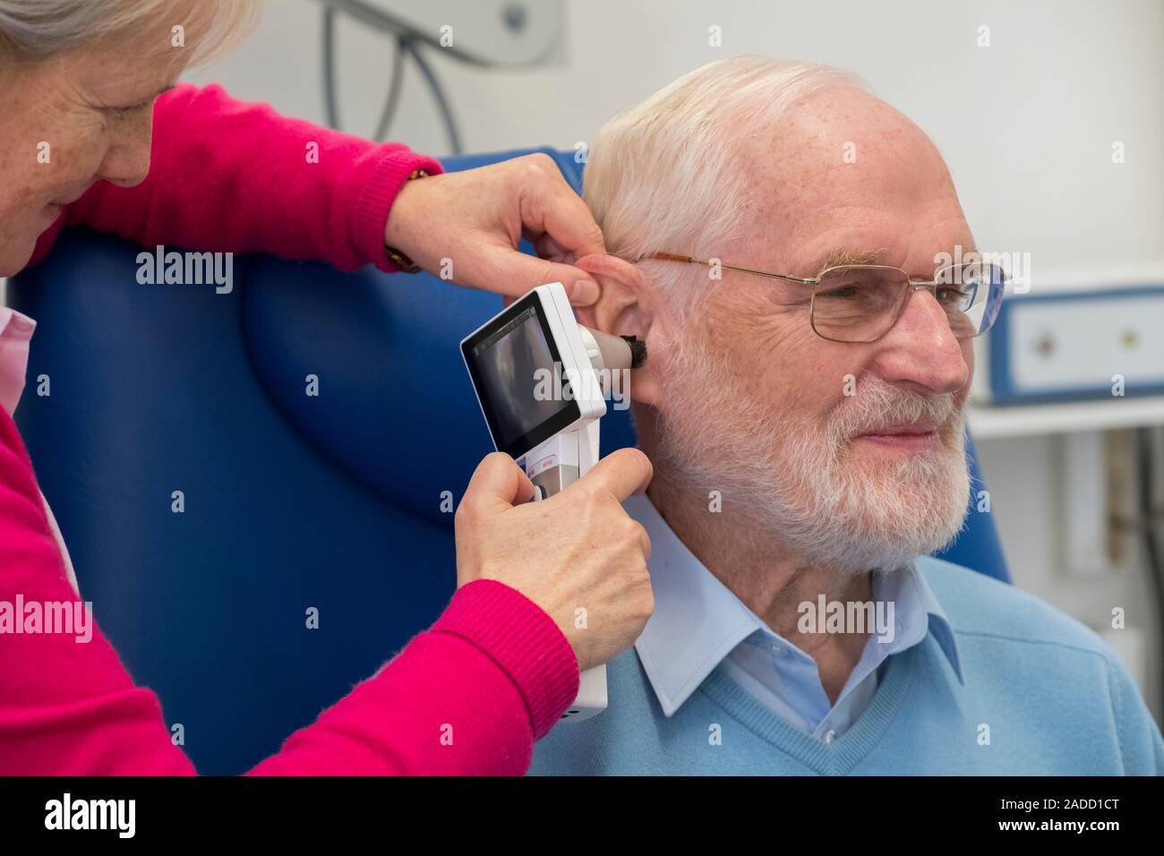 Ear wax removal clinic. Man having excess ear wax removed. Excessive ...